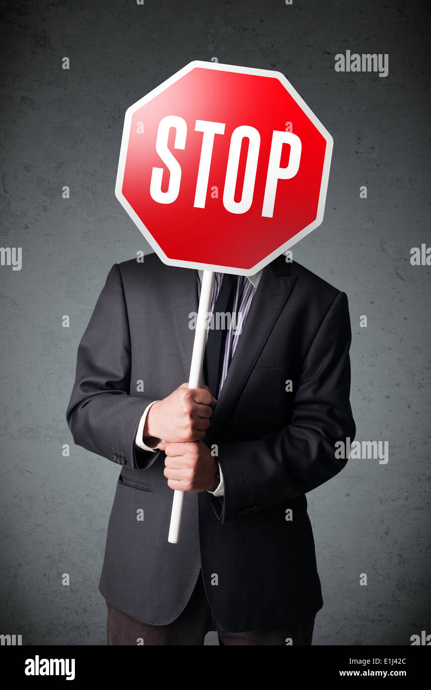 Businessman holding a stop sign Stock Photo - Alamy