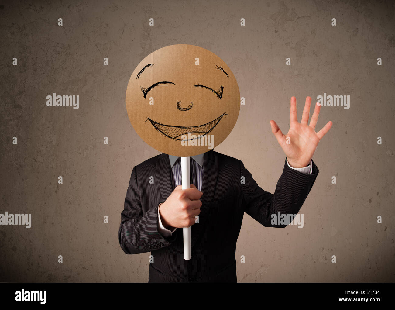 Businessman holding a smiley face board Stock Photo - Alamy