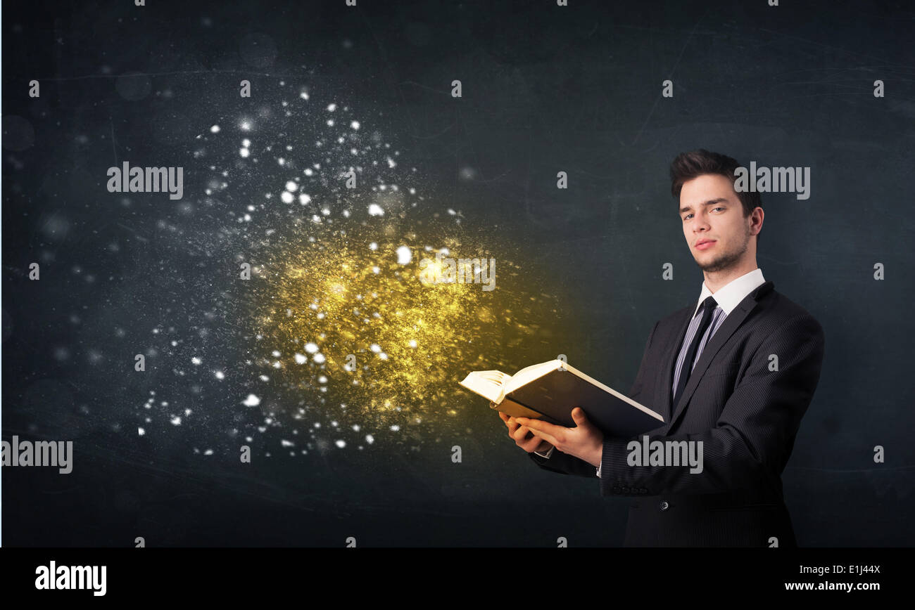 Young guy reading a magical book Stock Photo - Alamy