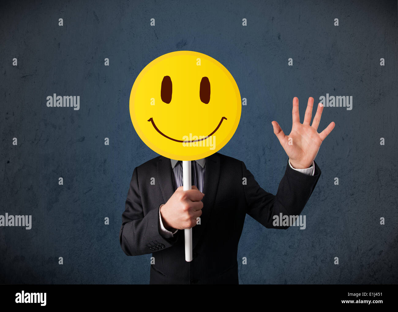 Businessman holding a smiley face emoticon Stock Photo - Alamy