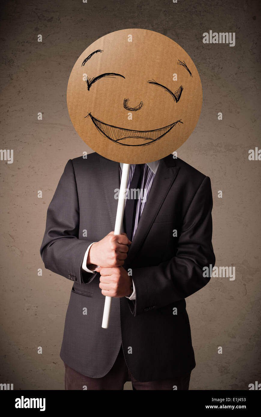 Businessman holding a smiley face board Stock Photo - Alamy