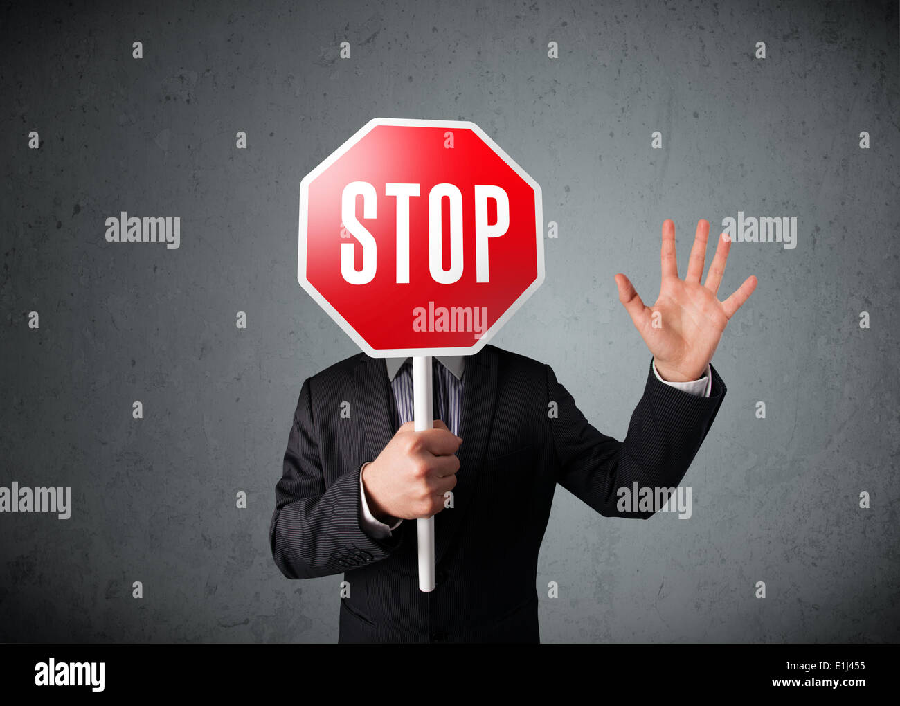 Businessman holding a stop sign Stock Photo - Alamy