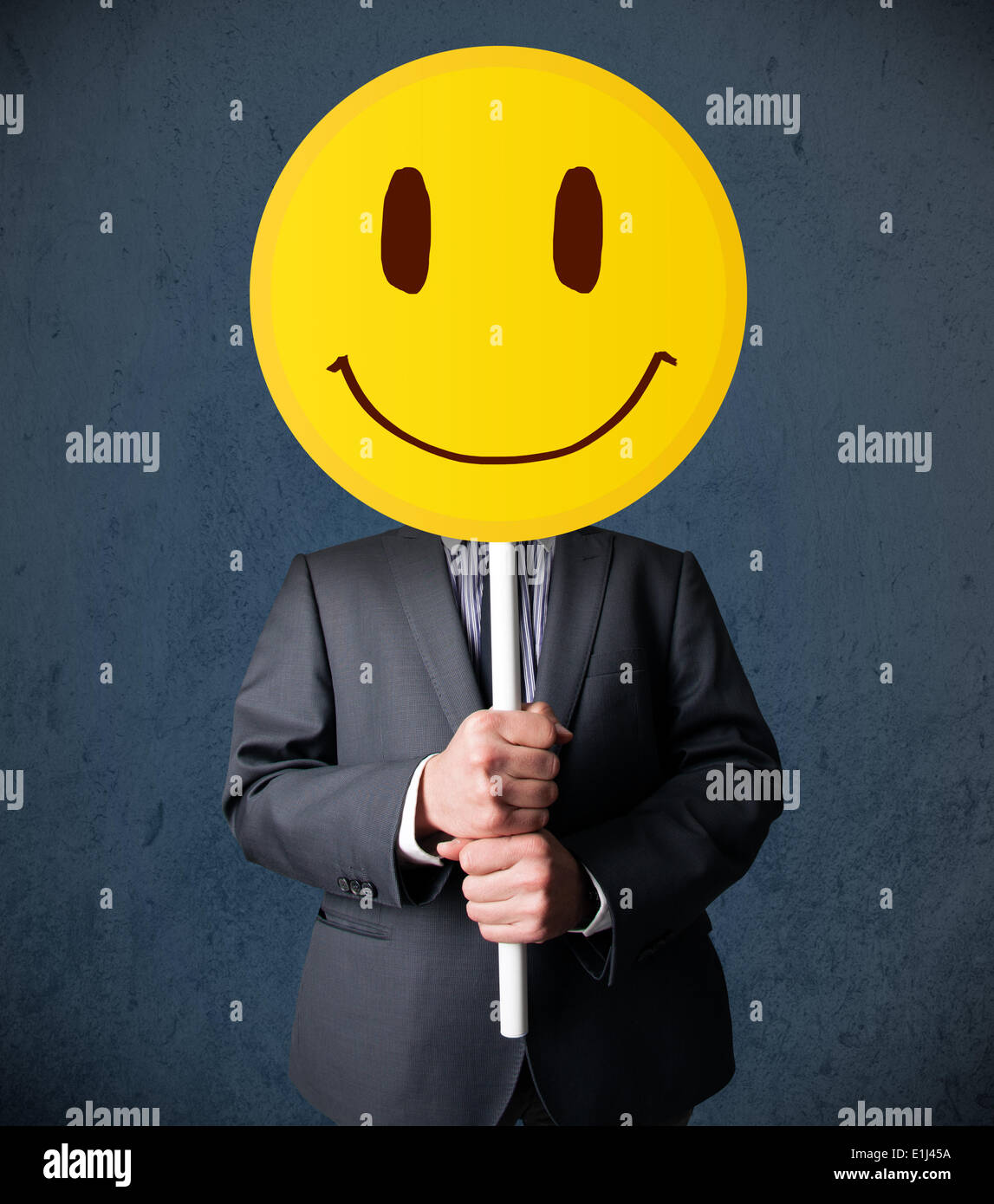 Businessman holding a smiley face emoticon Stock Photo - Alamy