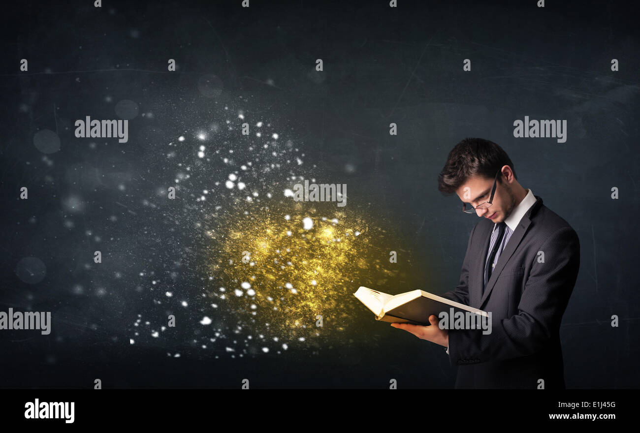 Young guy reading a magical book Stock Photo - Alamy