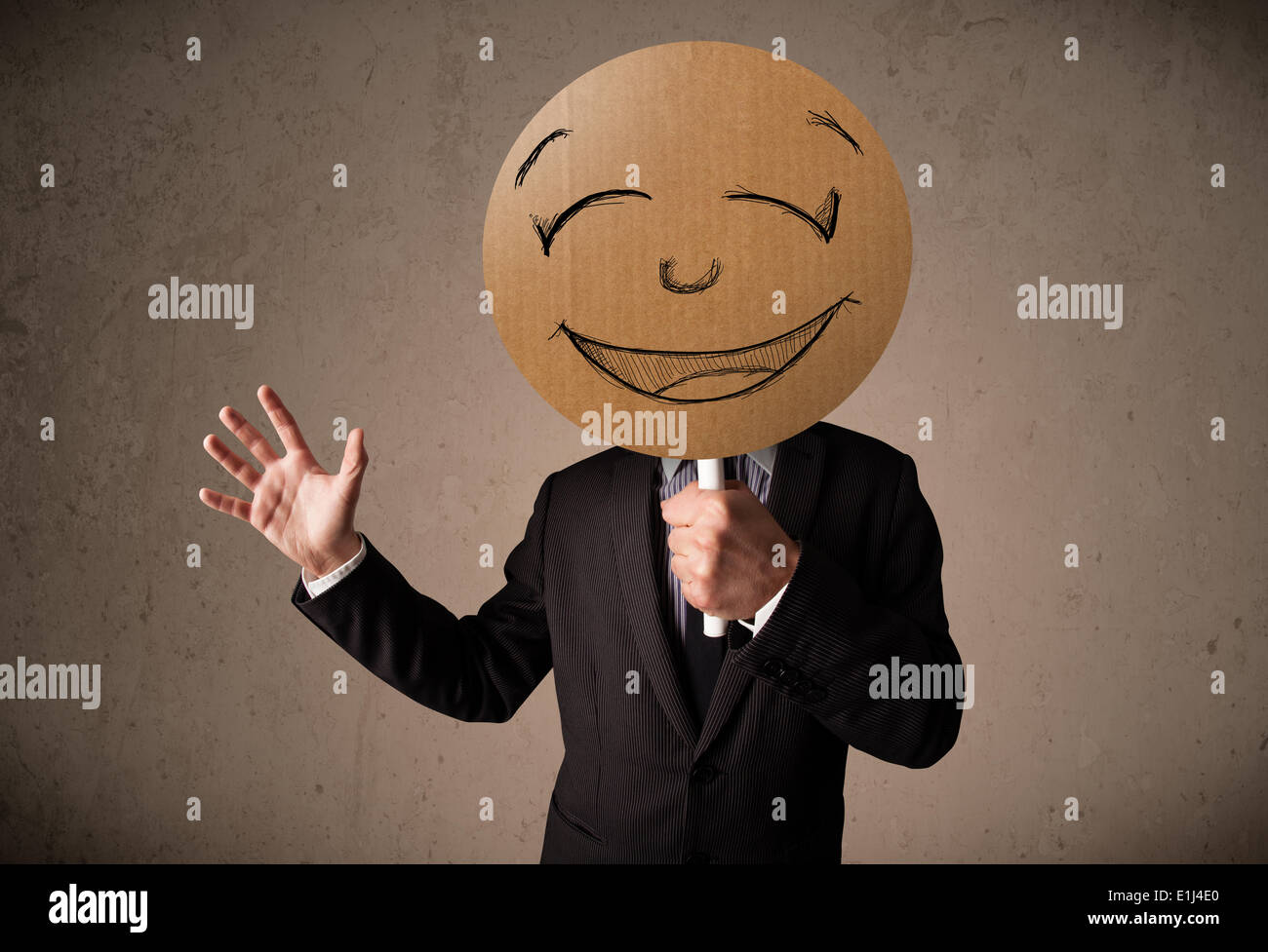 Businessman holding a smiley face board Stock Photo - Alamy