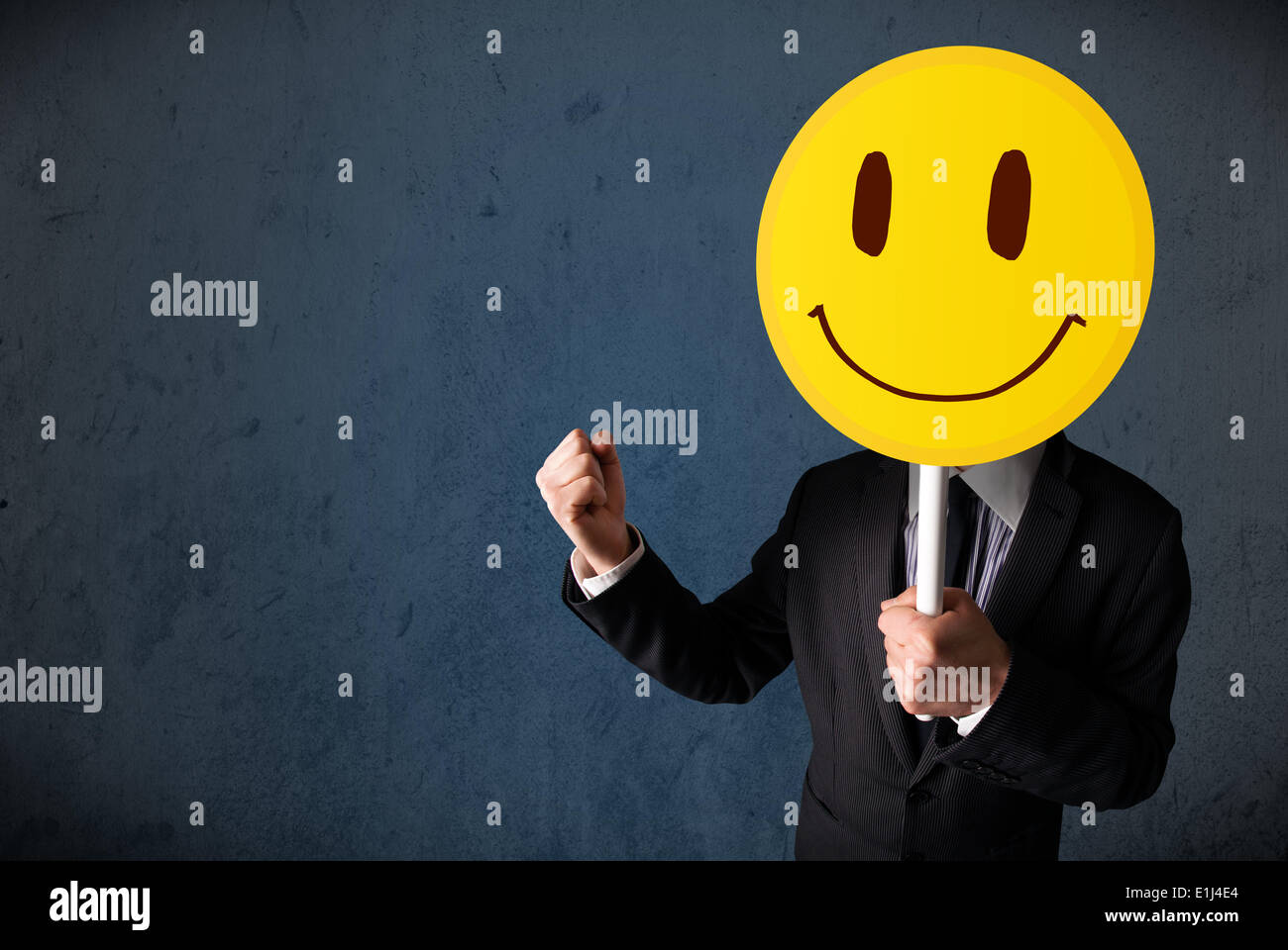 Businessman holding a smiley face emoticon Stock Photo - Alamy