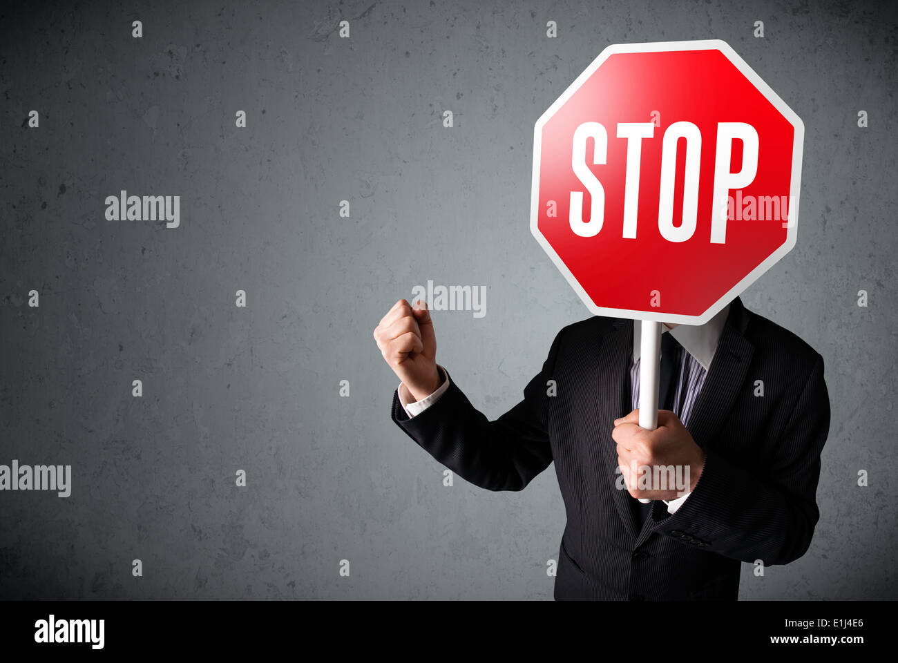 Businessman holding a stop sign Stock Photo - Alamy