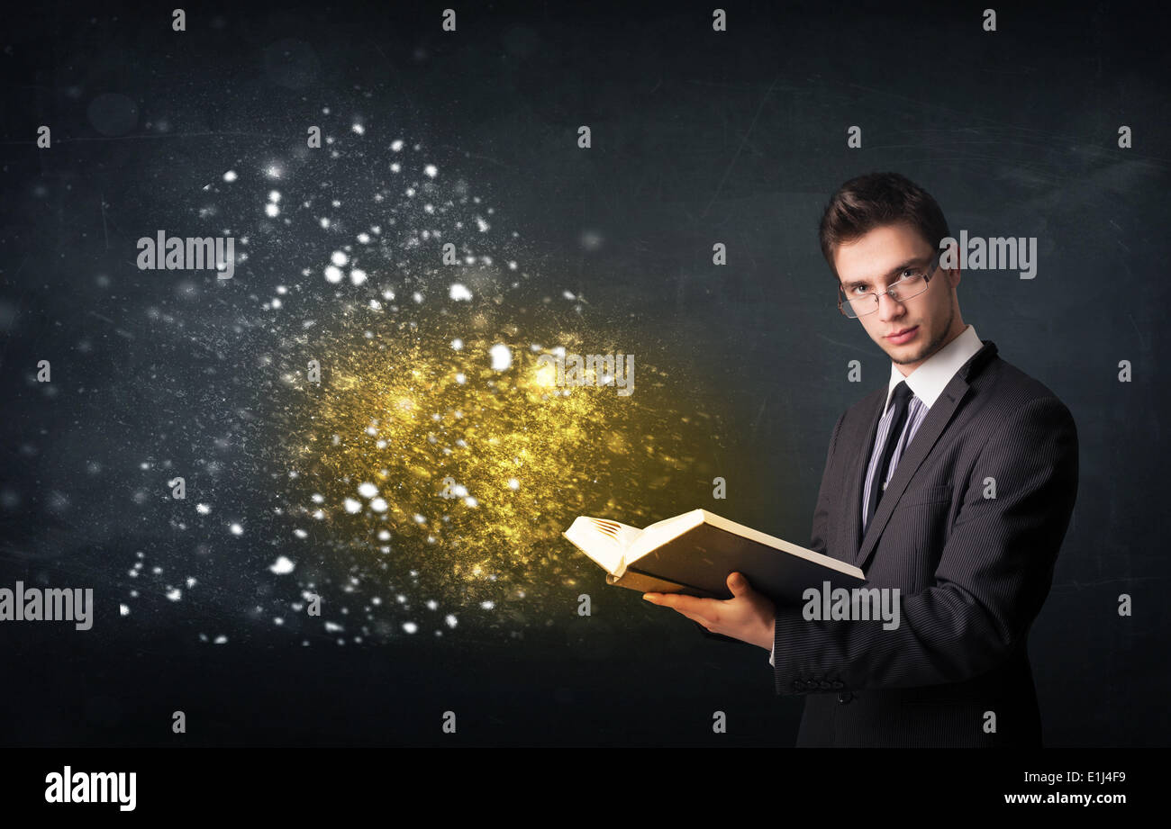 Young guy reading a magical book Stock Photo - Alamy