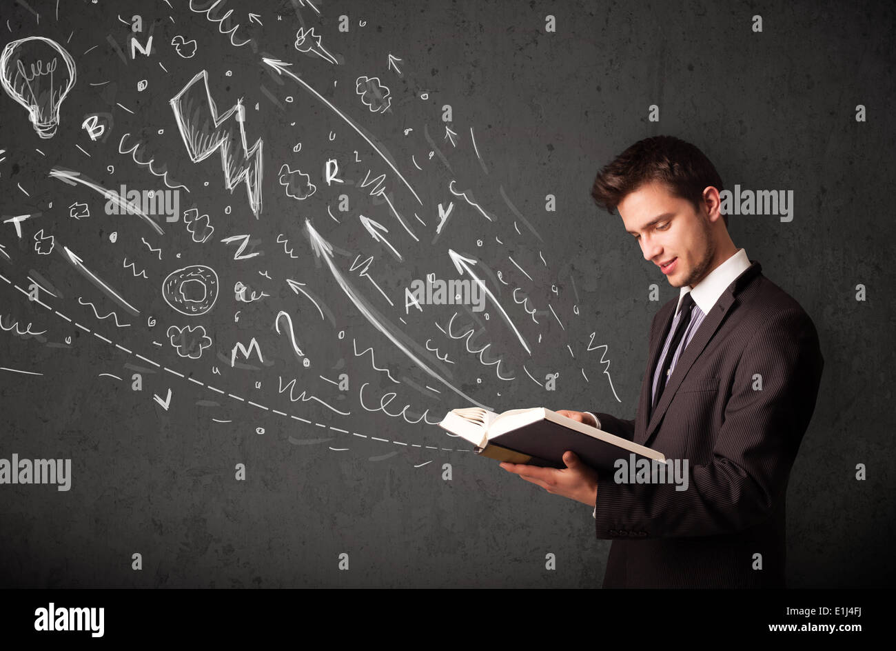 Young man reading a book Stock Photo - Alamy