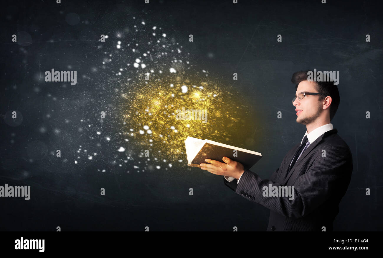 Young guy reading a magical book Stock Photo - Alamy