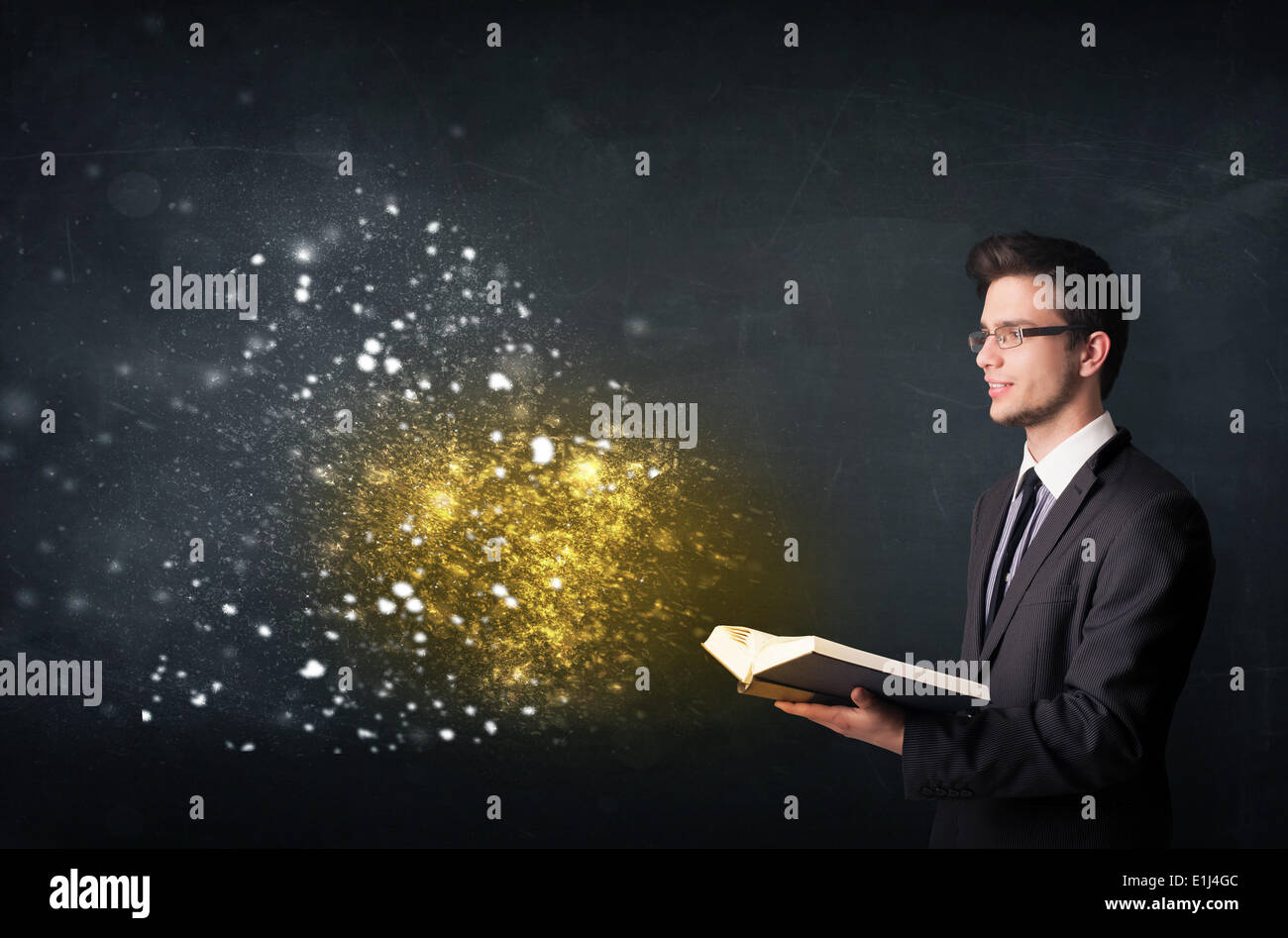 Young guy reading a magical book Stock Photo - Alamy