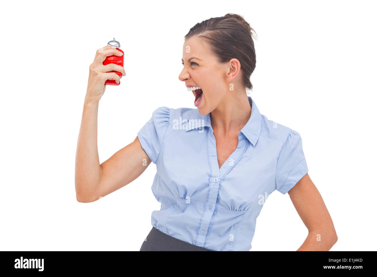 Businesswoman screaming at alarm clock Stock Photo - Alamy