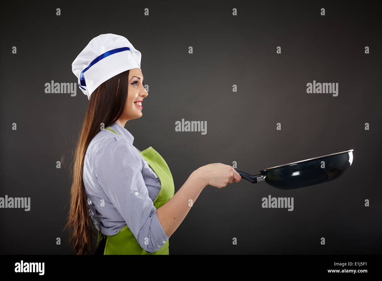 Young female chef holding wok hi-res stock photography and images - Alamy