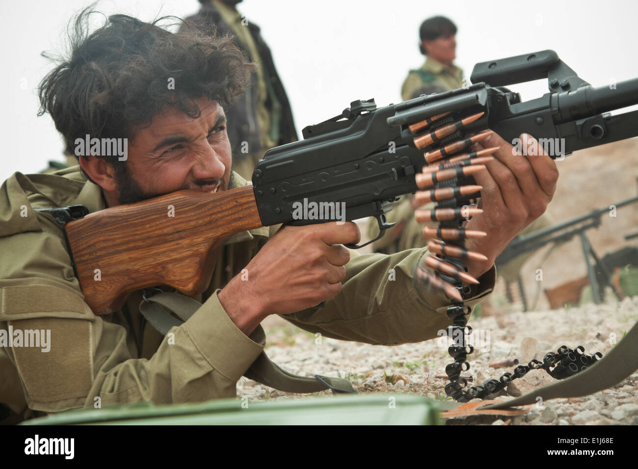 An Afghan Local Police officer fires a machine gun during live-fire ...