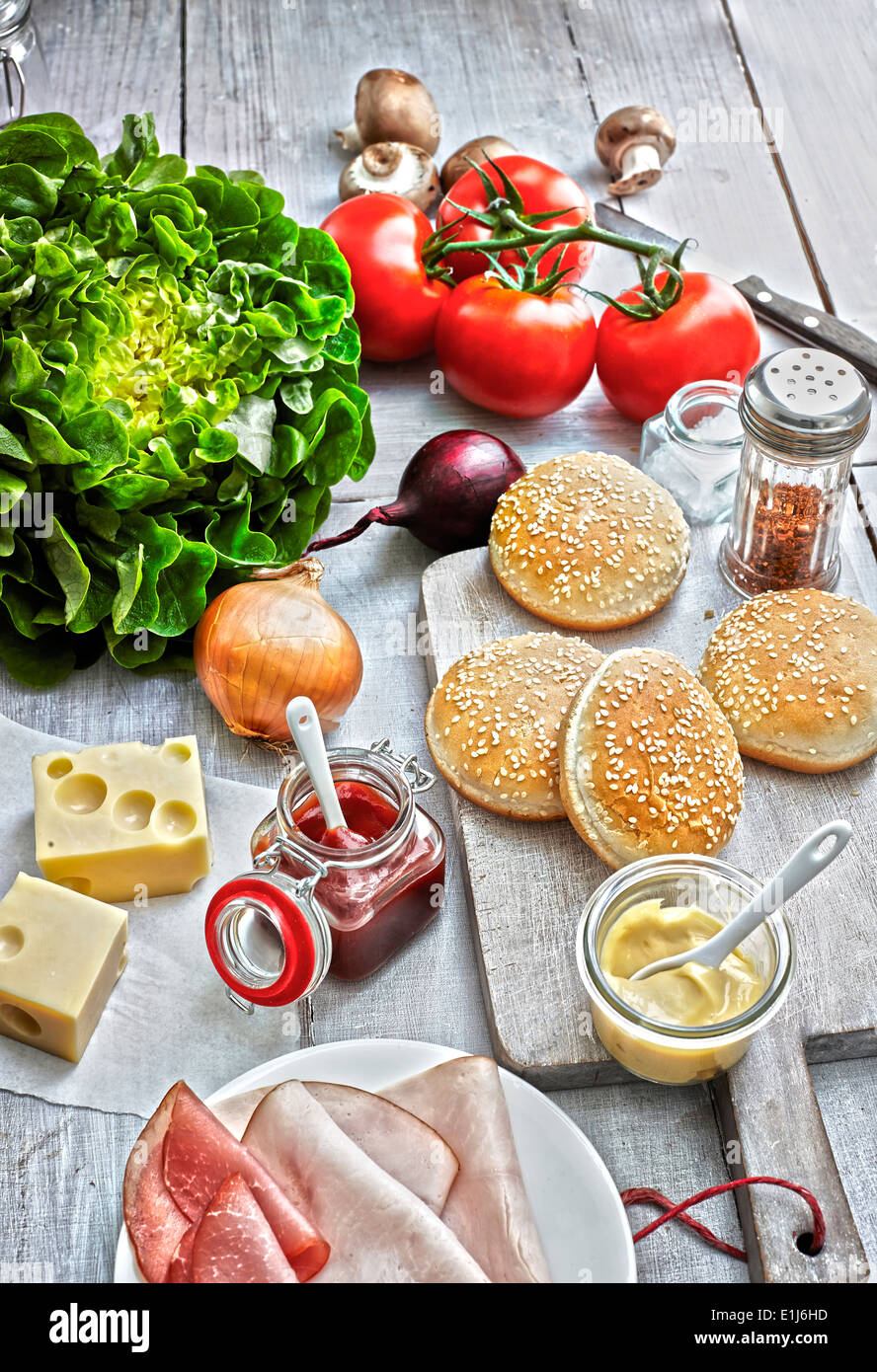 Ingredients of burgers on light ground Stock Photo - Alamy