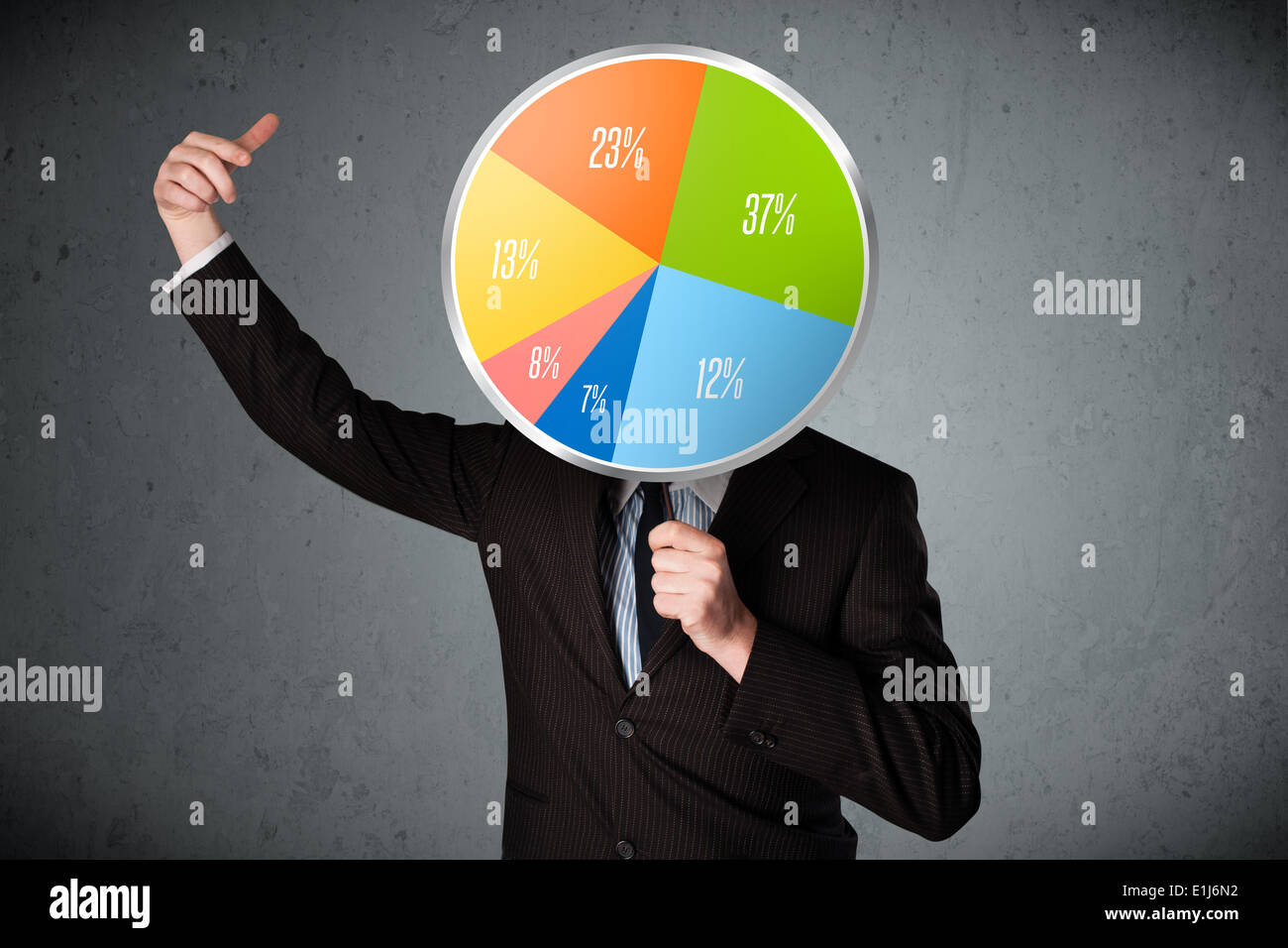 Businessman holding a pie chart Stock Photo - Alamy