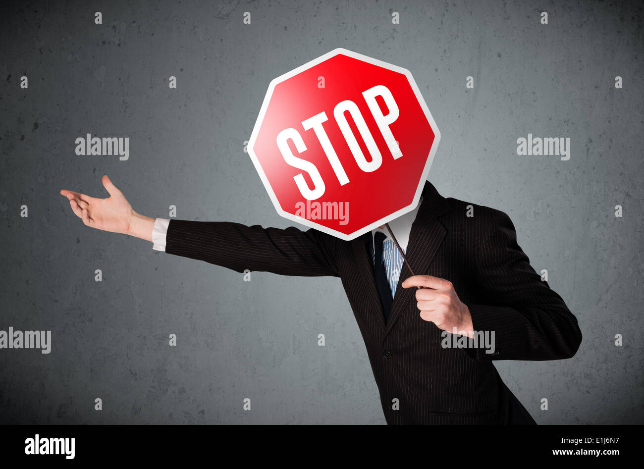 Businessman holding a stop sign Stock Photo - Alamy