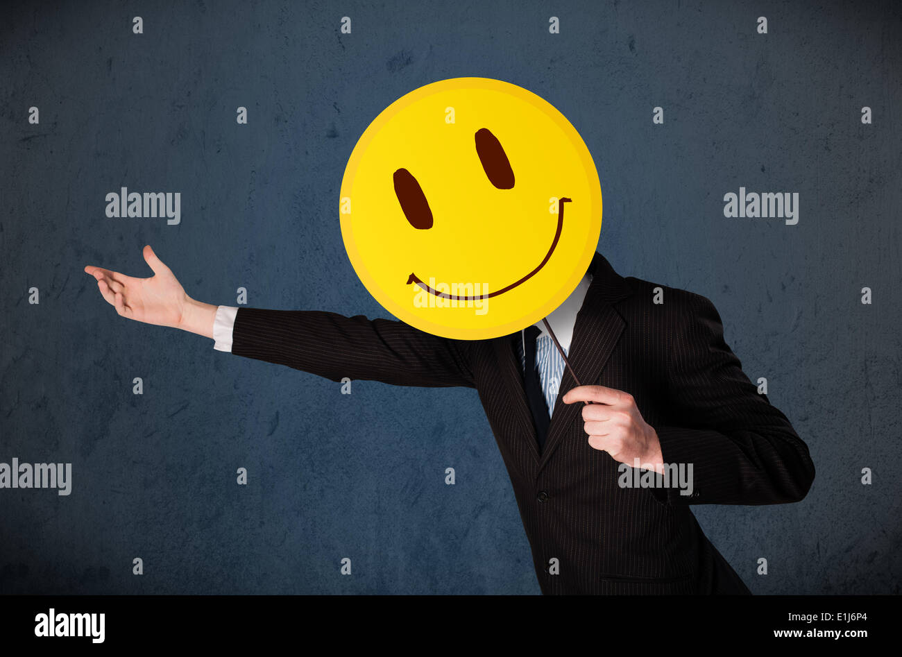 Businessman holding a smiley face emoticon Stock Photo - Alamy