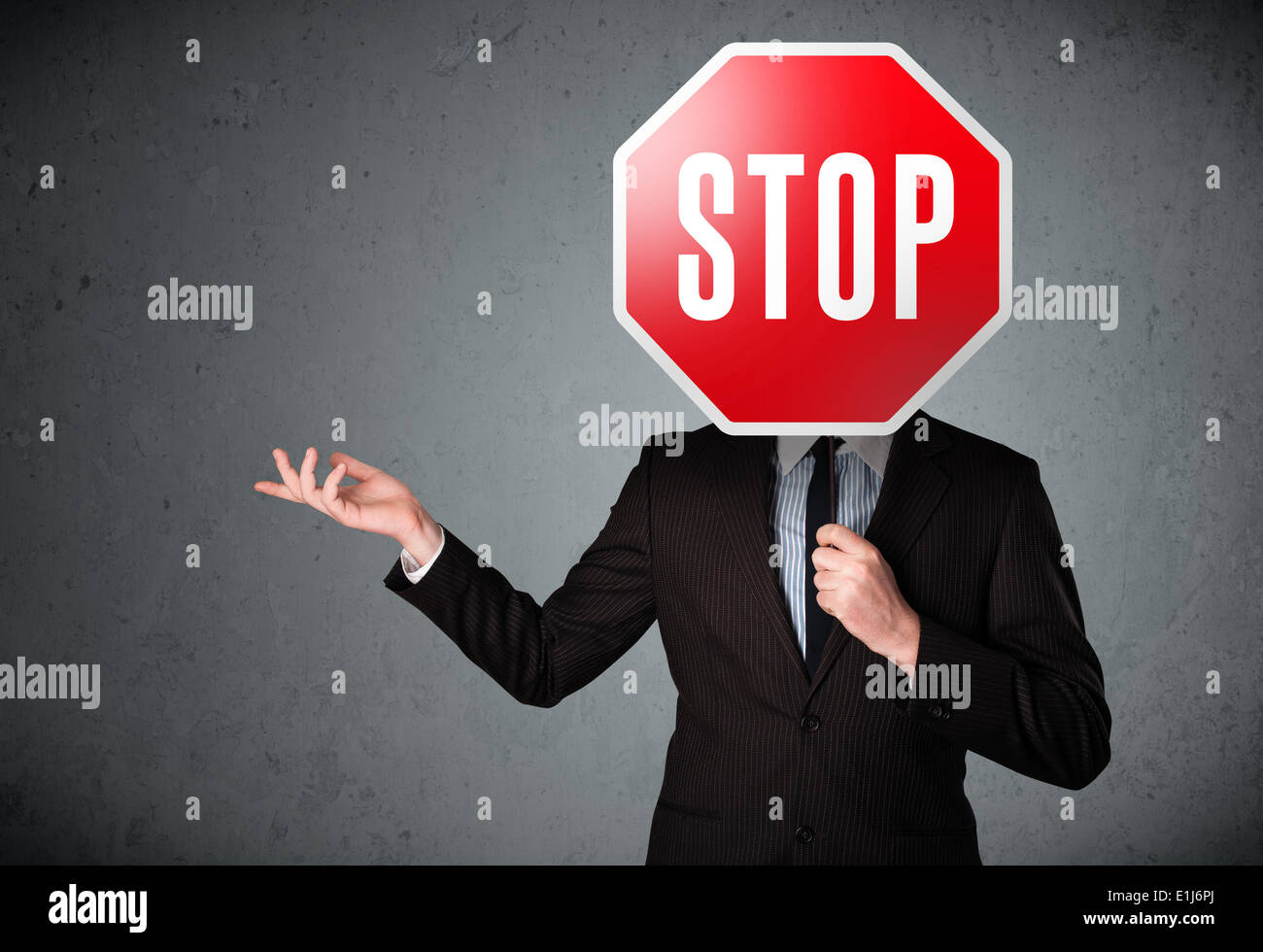 Businessman holding a stop sign Stock Photo - Alamy