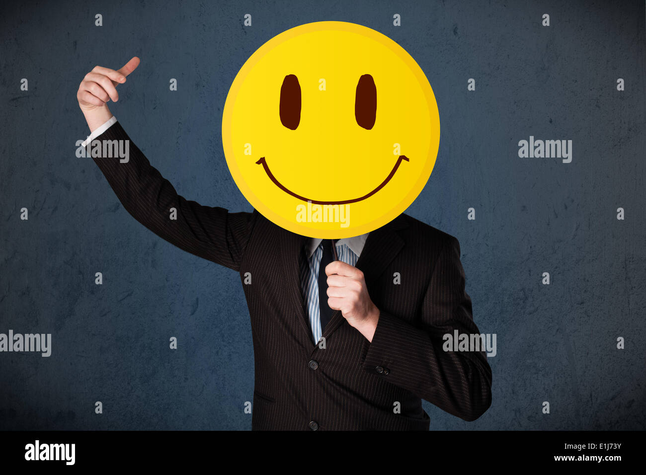 Businessman holding a smiley face emoticon Stock Photo - Alamy