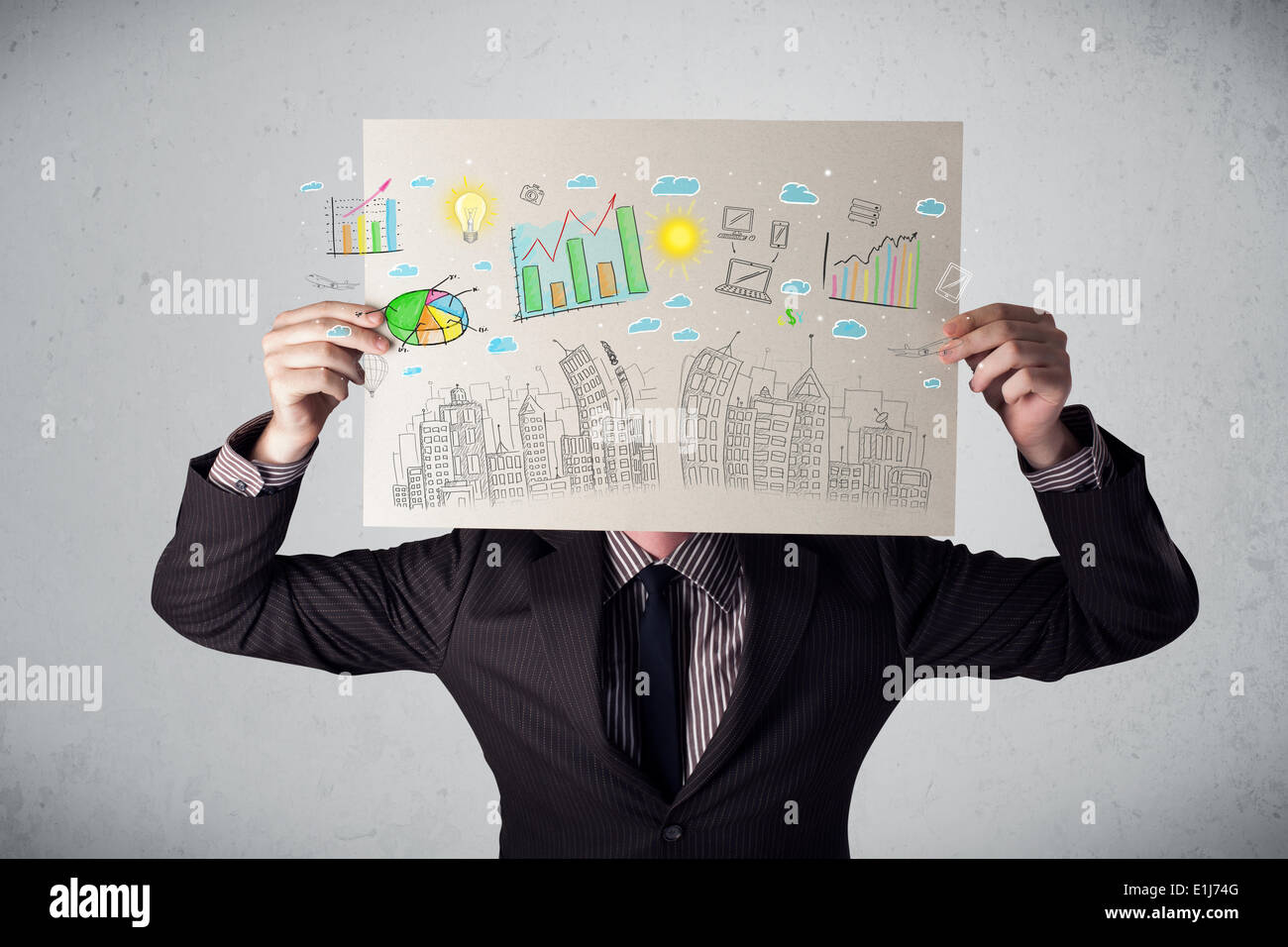 Businessman holding a paper with charts and cityscape in front of his ...