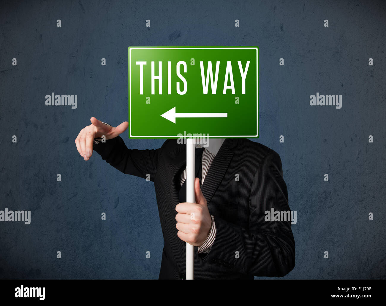 Businessman holding a direction sign Stock Photo - Alamy