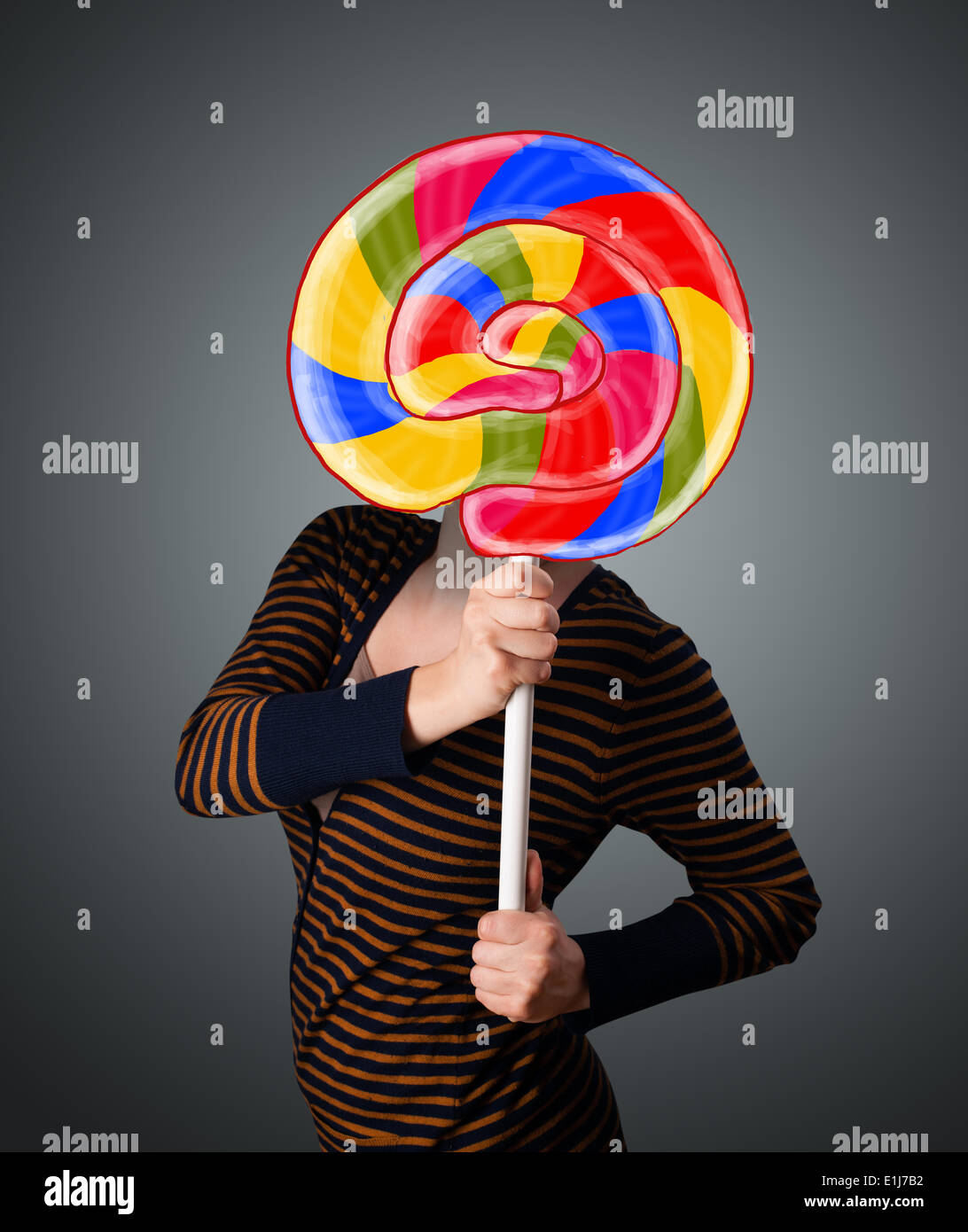 Young woman holding a lollipop Stock Photo - Alamy