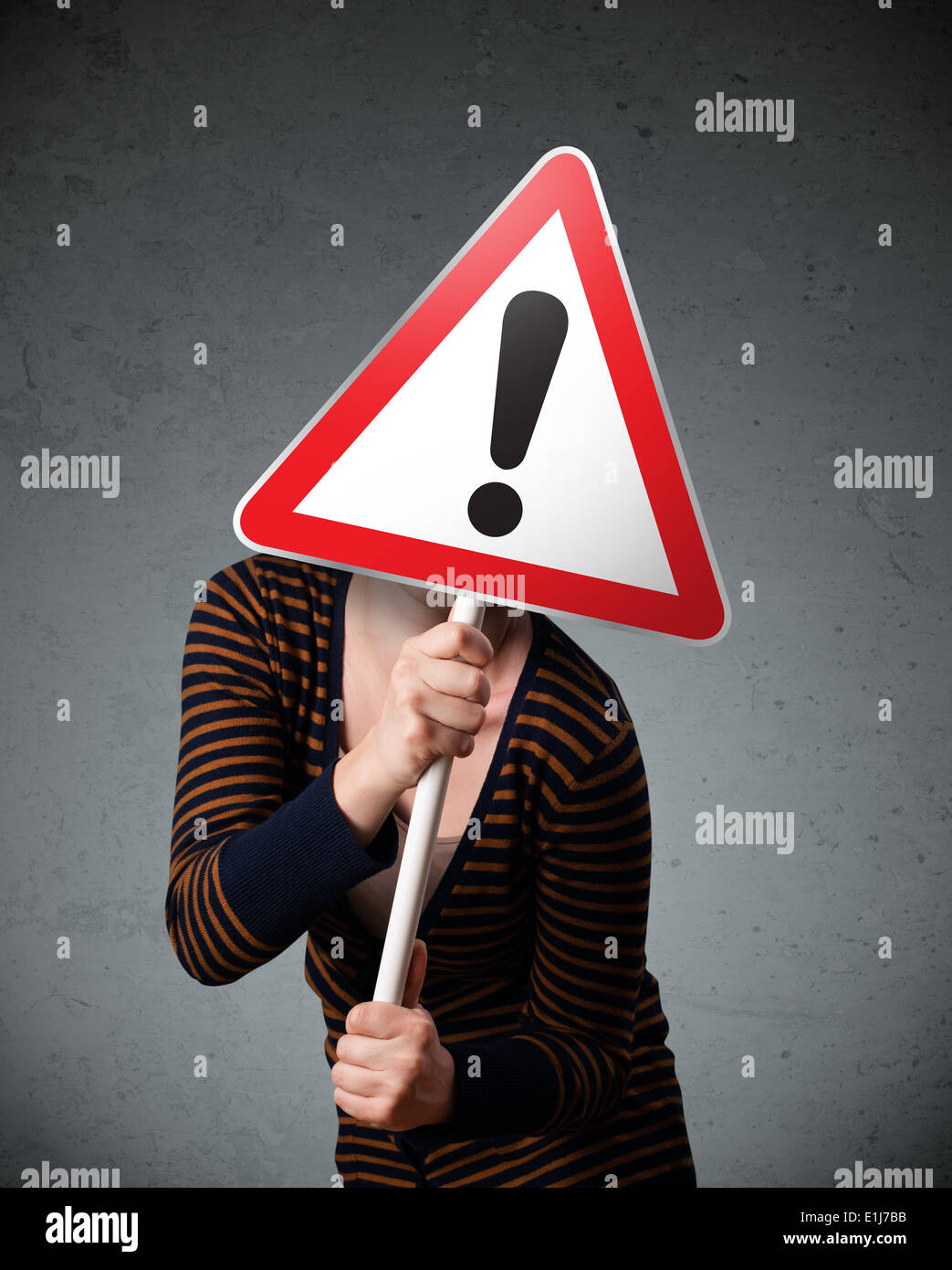 Young woman holding an exclamation road sign Stock Photo - Alamy