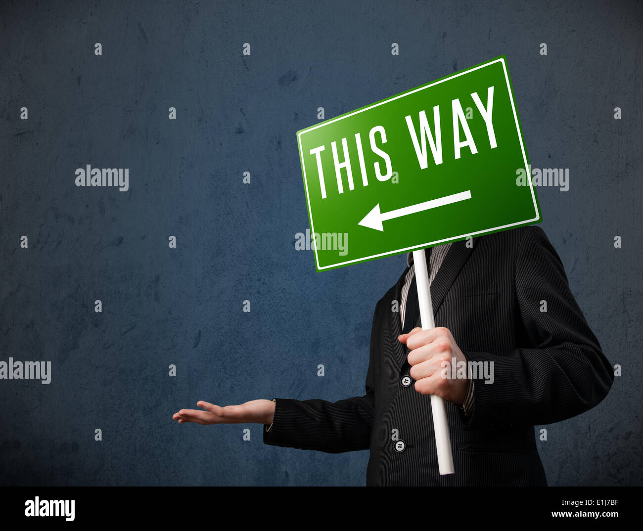 Businessman holding a direction sign Stock Photo - Alamy