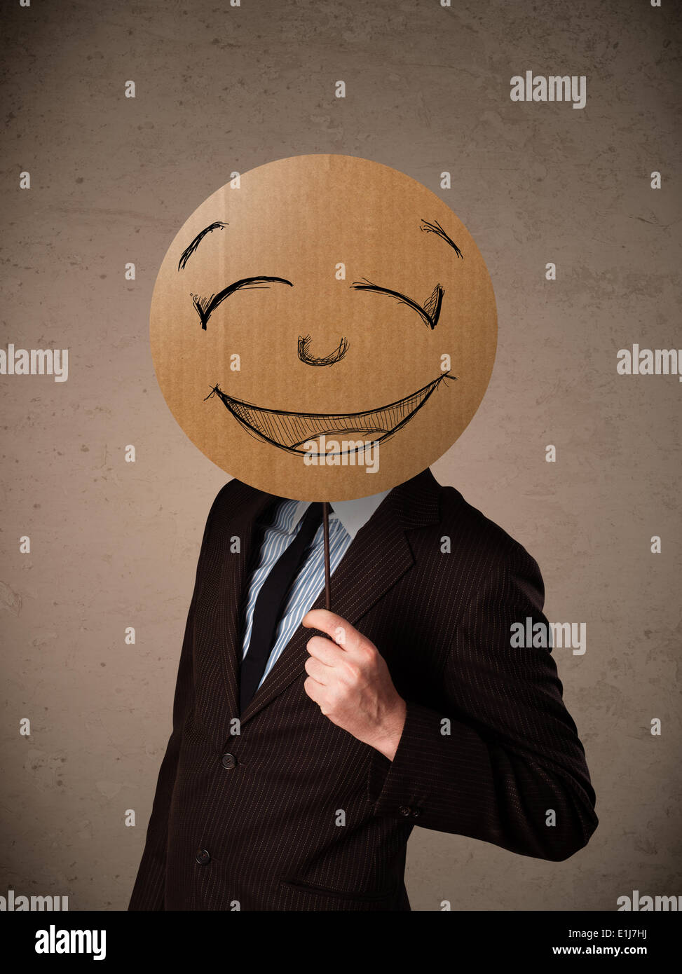 Businessman holding a smiley face board Stock Photo - Alamy