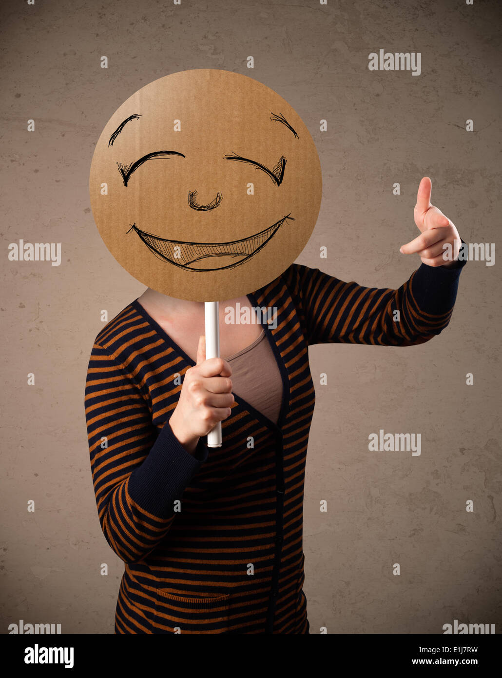 Young woman holding a smiley face board Stock Photo - Alamy