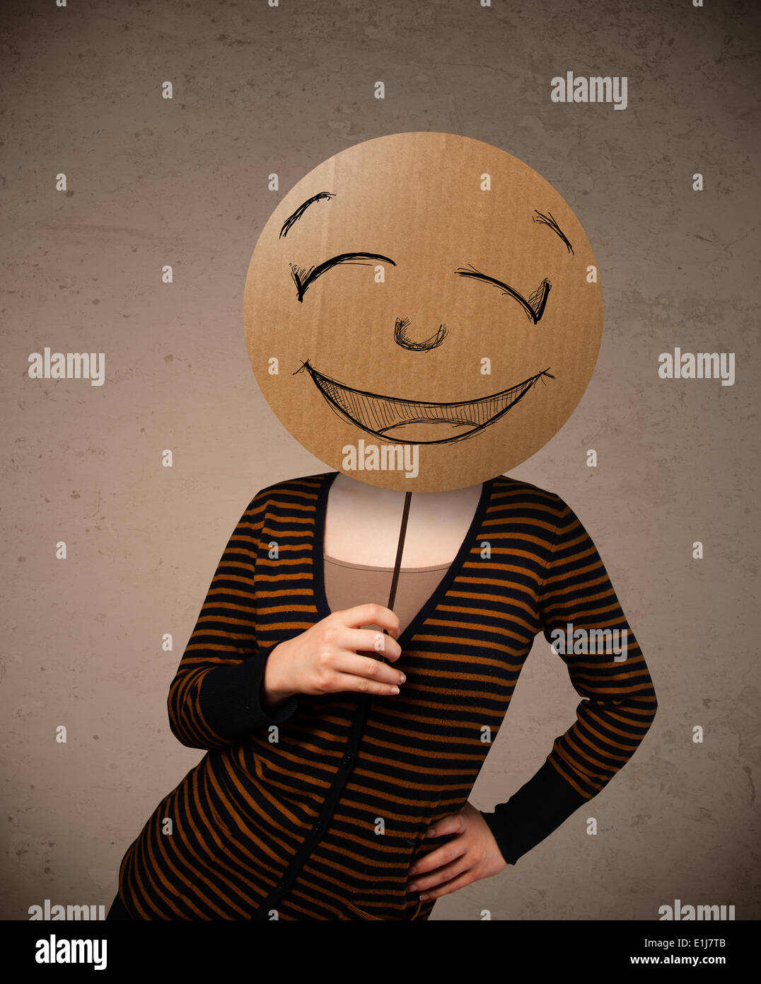 Young woman holding a smiley face board Stock Photo - Alamy