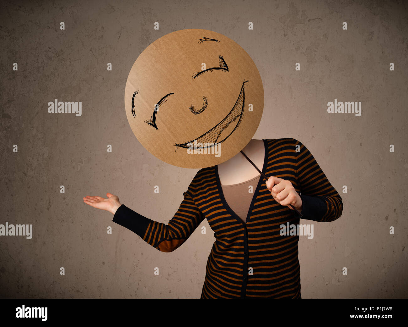 Young woman holding a smiley face board Stock Photo - Alamy