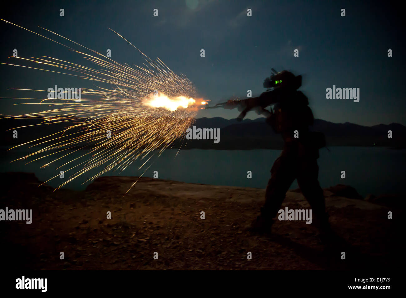 A U.S. Marine fires an AK-47 rifle during night-fire sustainment ...