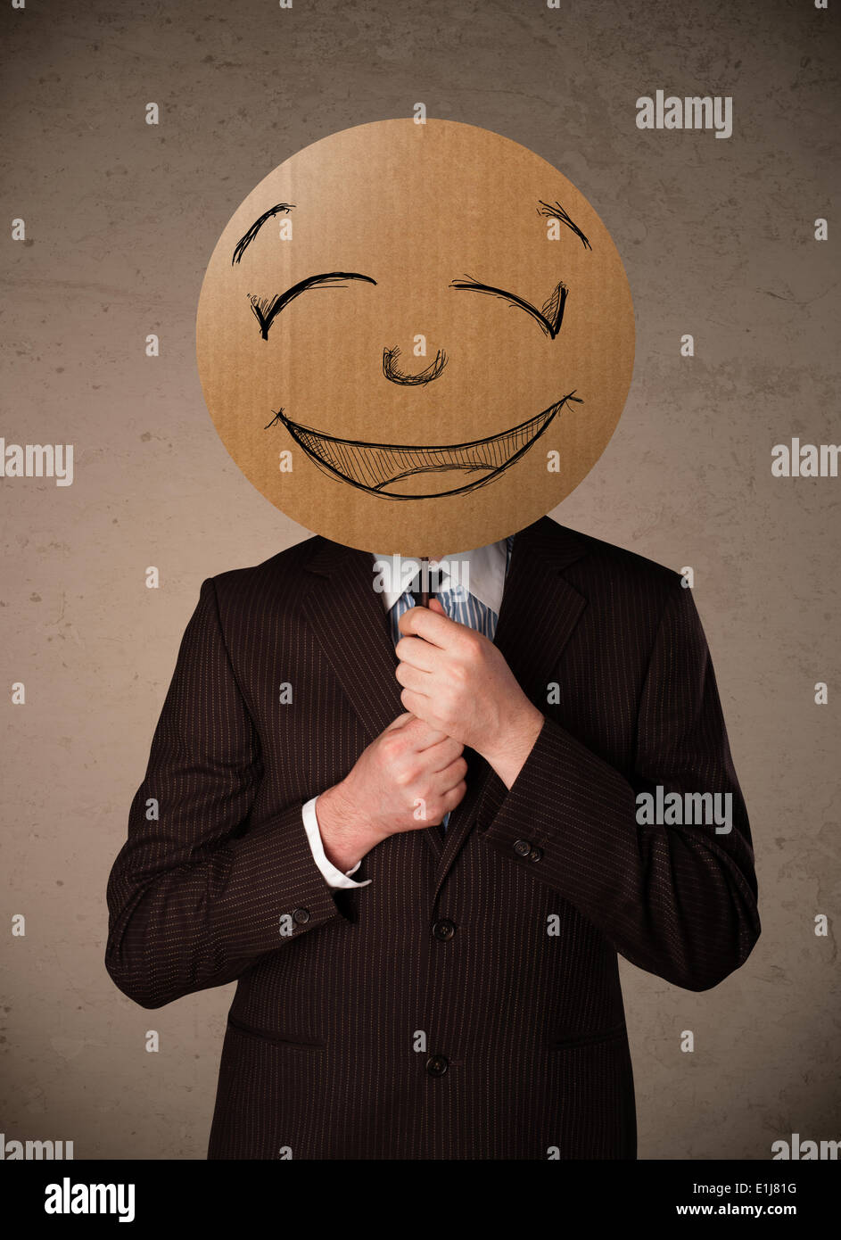 Businessman holding a smiley face board Stock Photo - Alamy