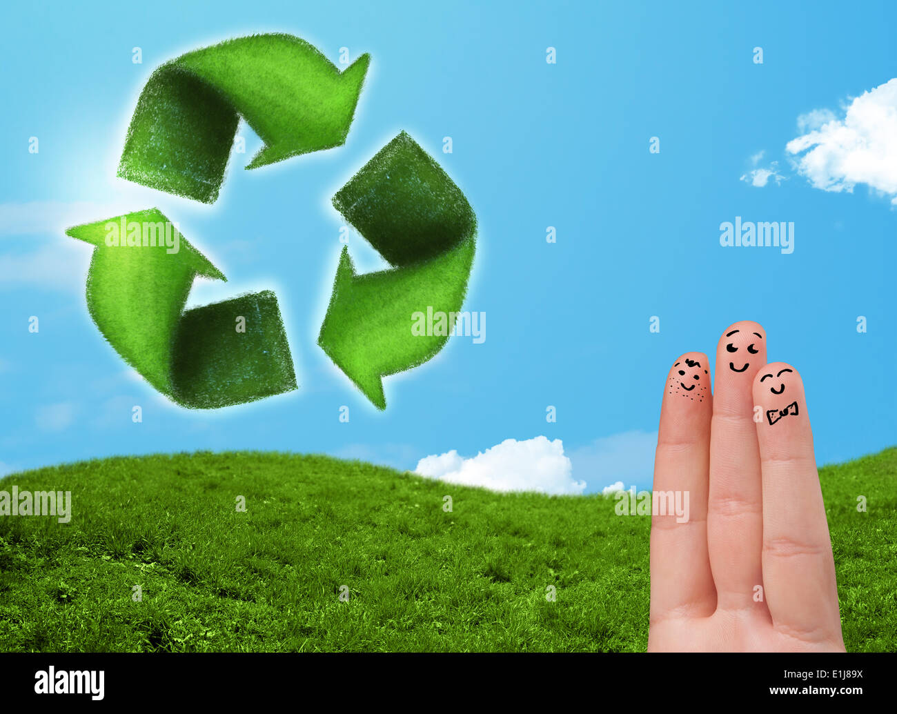 Happy smiley fingers looking at green leaf recycle sign Stock Photo - Alamy