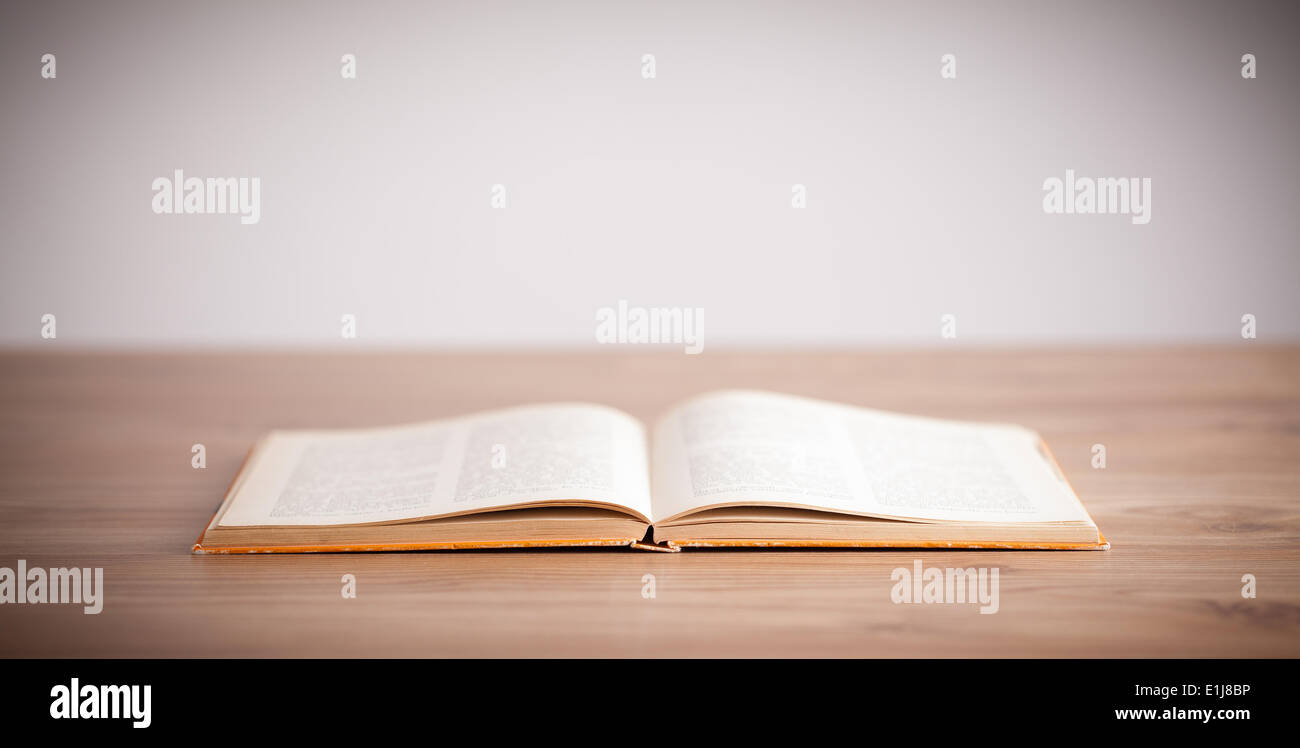 Open Book on wood background Stock Photo - Alamy