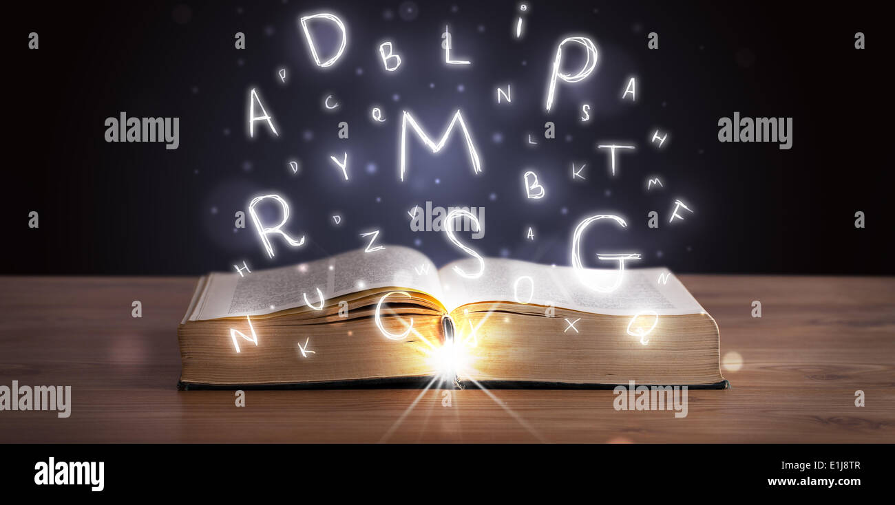 Open book with glowing letters flying out Stock Photo - Alamy