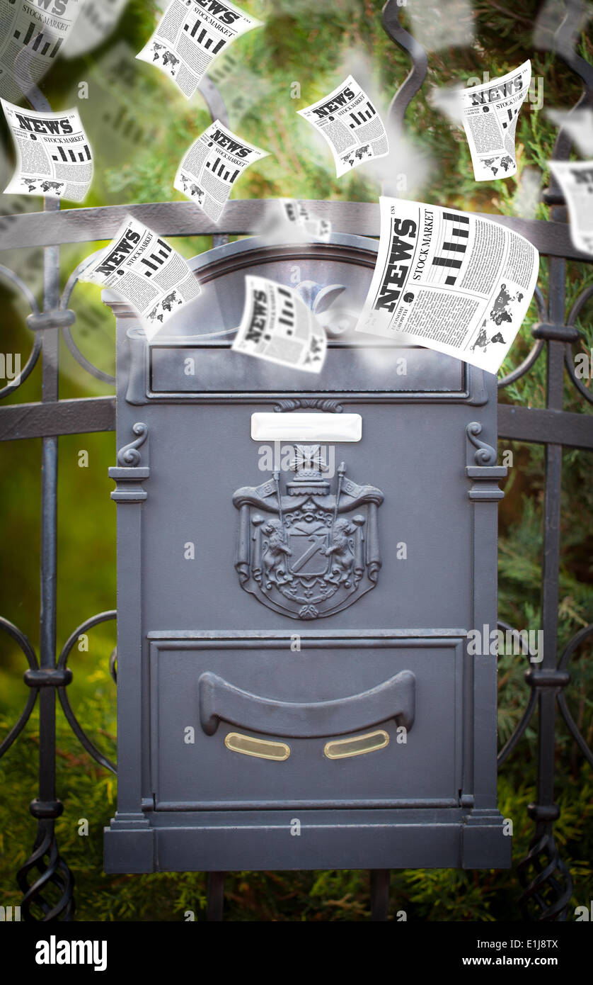 Post box with daily newspapers flying Stock Photo - Alamy