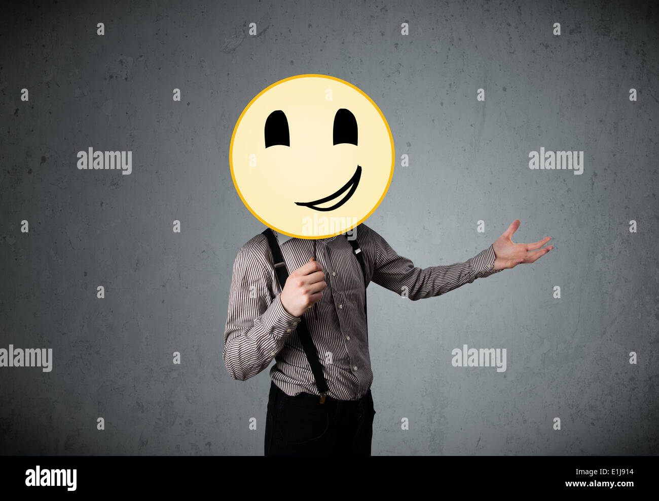 Businessman holding a smiley face emoticon Stock Photo - Alamy