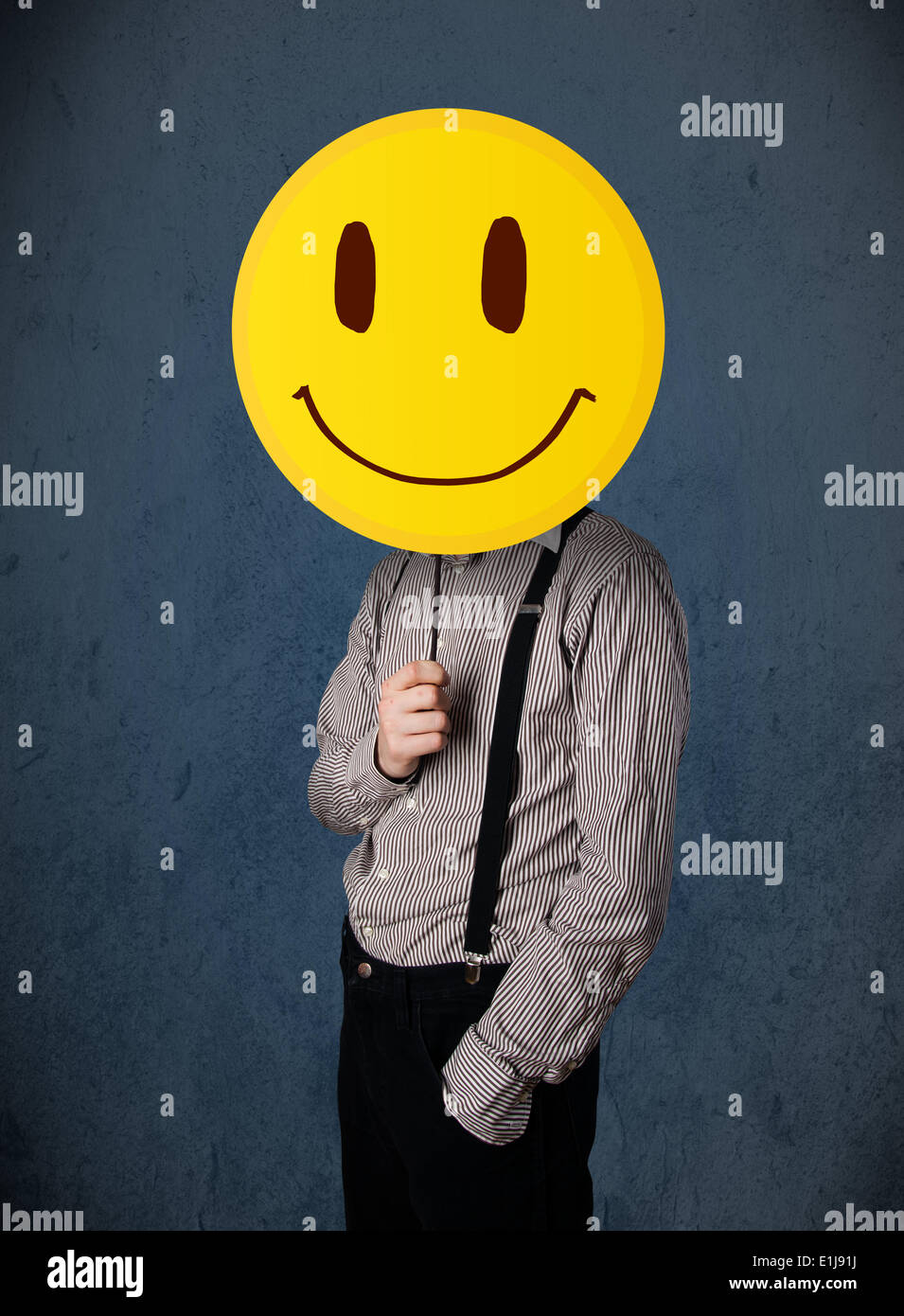 Businessman holding a smiley face emoticon Stock Photo - Alamy