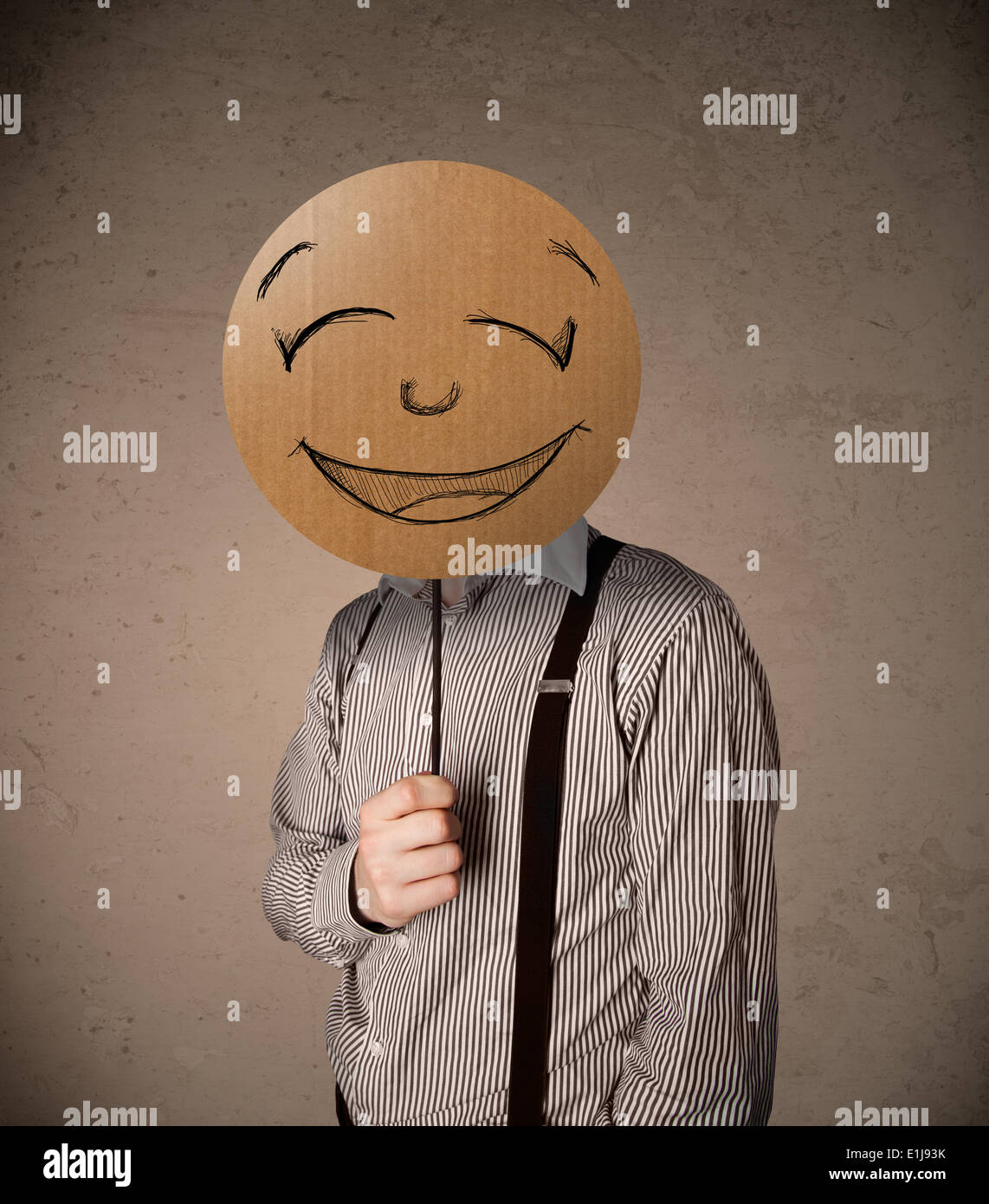 Businessman holding a smiley face board Stock Photo - Alamy