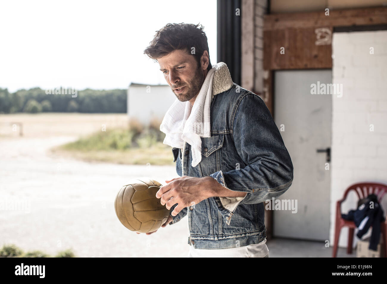 Portrait of man holding football Stock Photo - Alamy