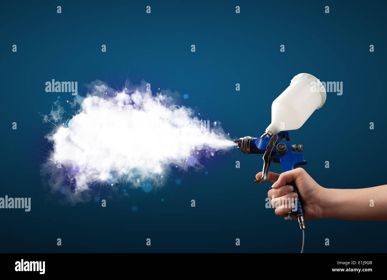 Painter with airbrush gun and white magical smoke Stock Photo - Alamy