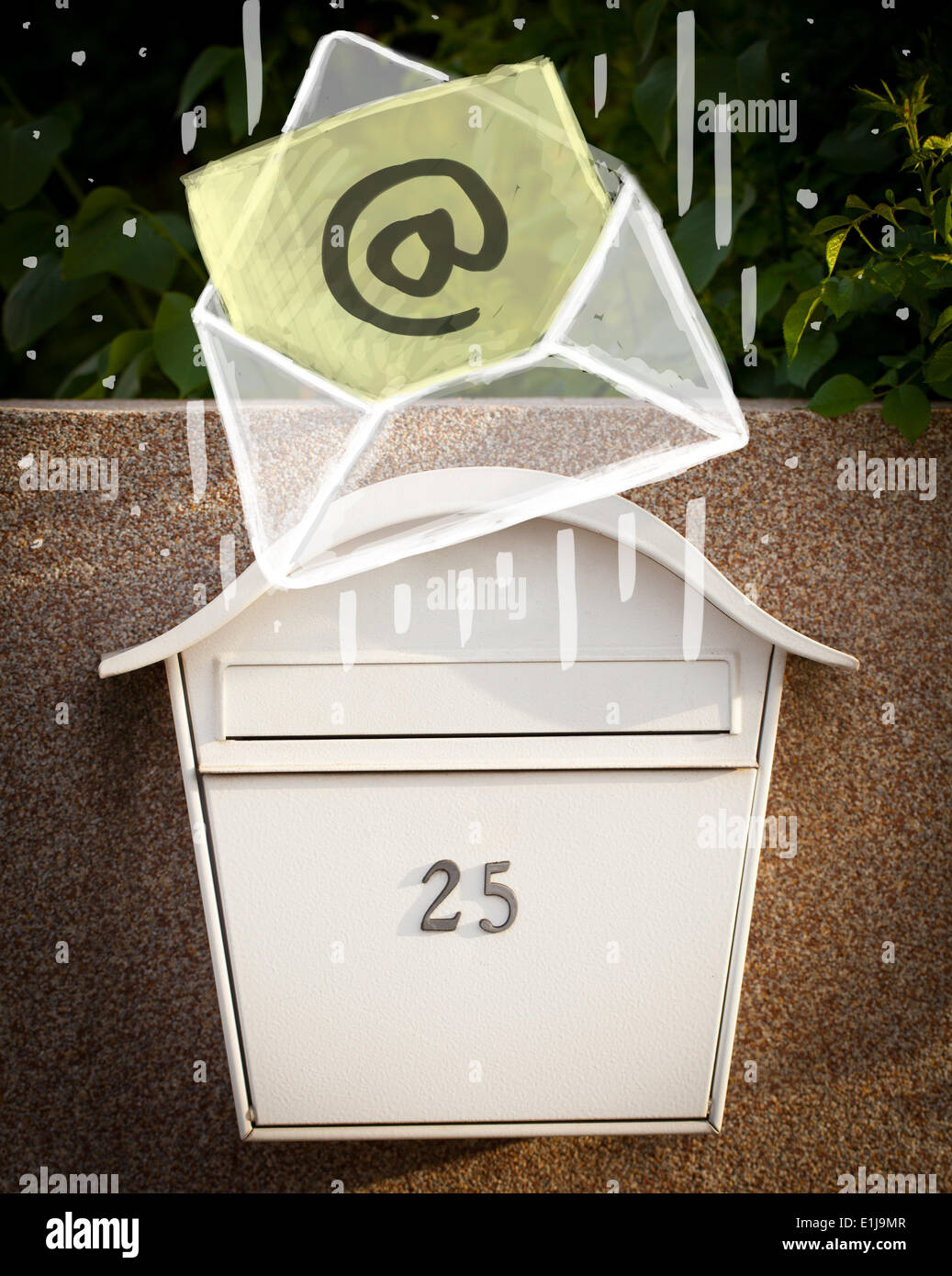 Envelope with email sign dropping into mailbox Stock Photo - Alamy