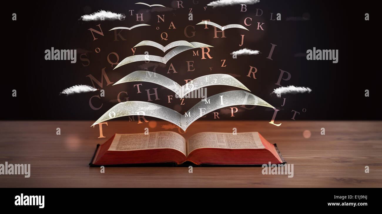 Pages and glowing letters flying out of a book Stock Photo - Alamy