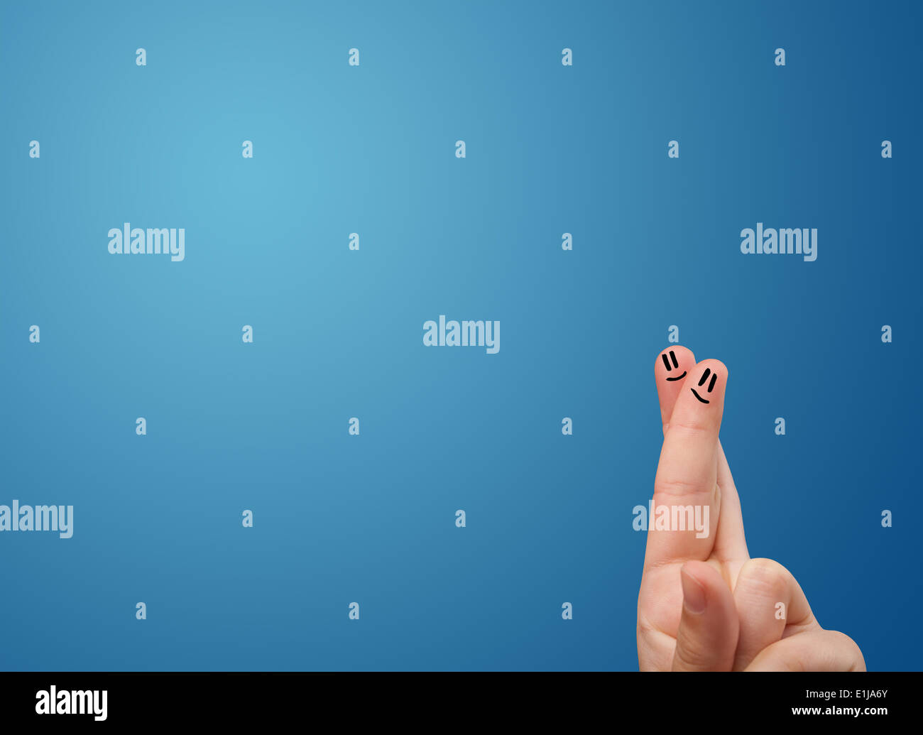 Happy smiley face fingers looking at empty blue background copy space ...