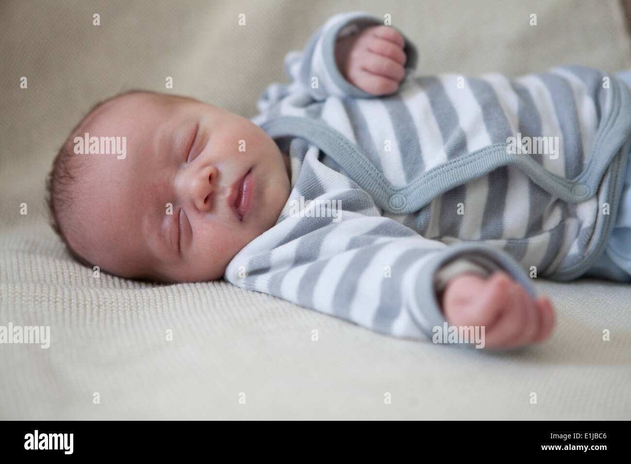 Portrait of sleeping baby boy lying on blanket Stock Photo - Alamy