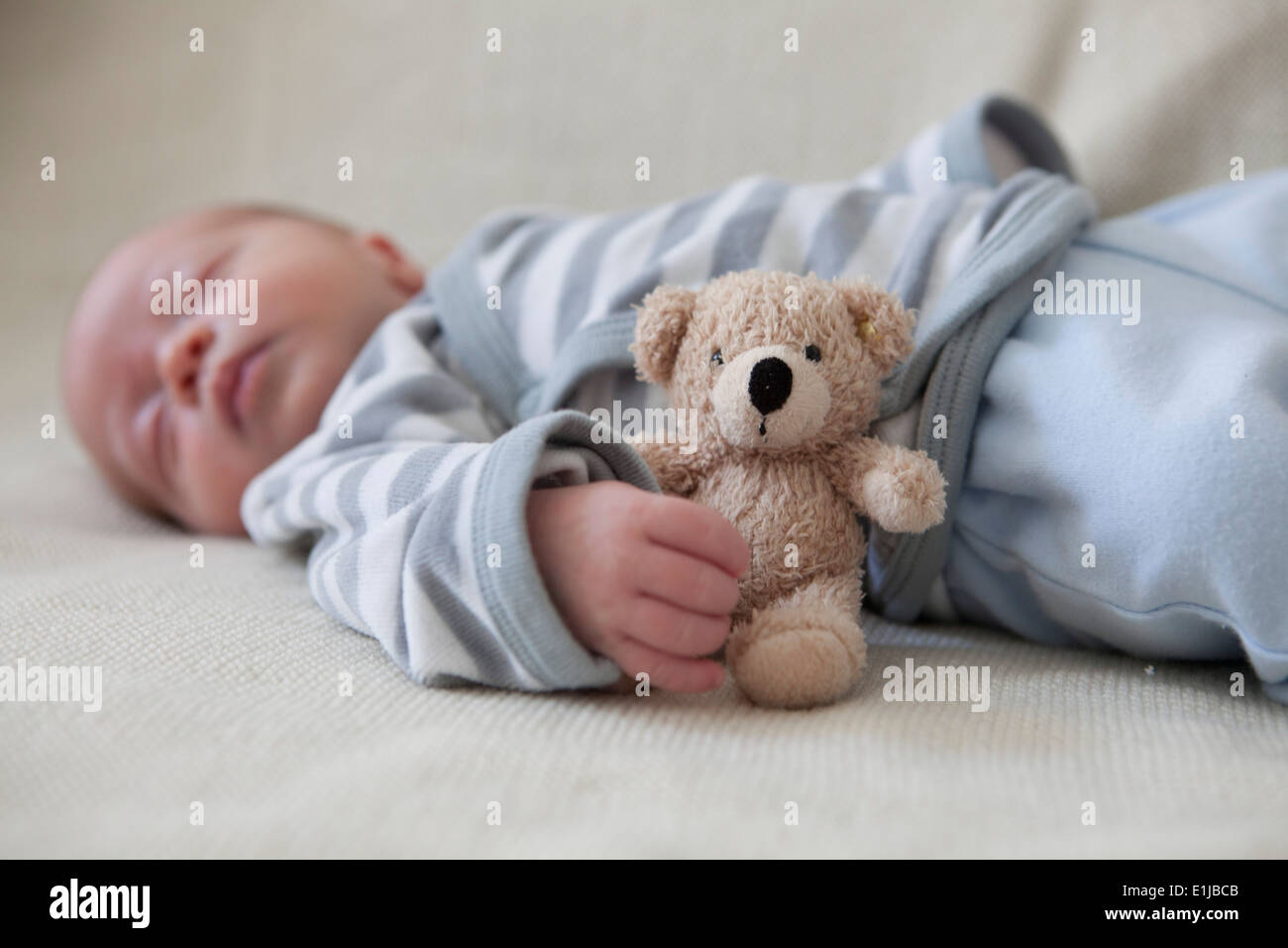 Portrait of sleeping baby boy lying on blanket with teddy Stock Photo ...