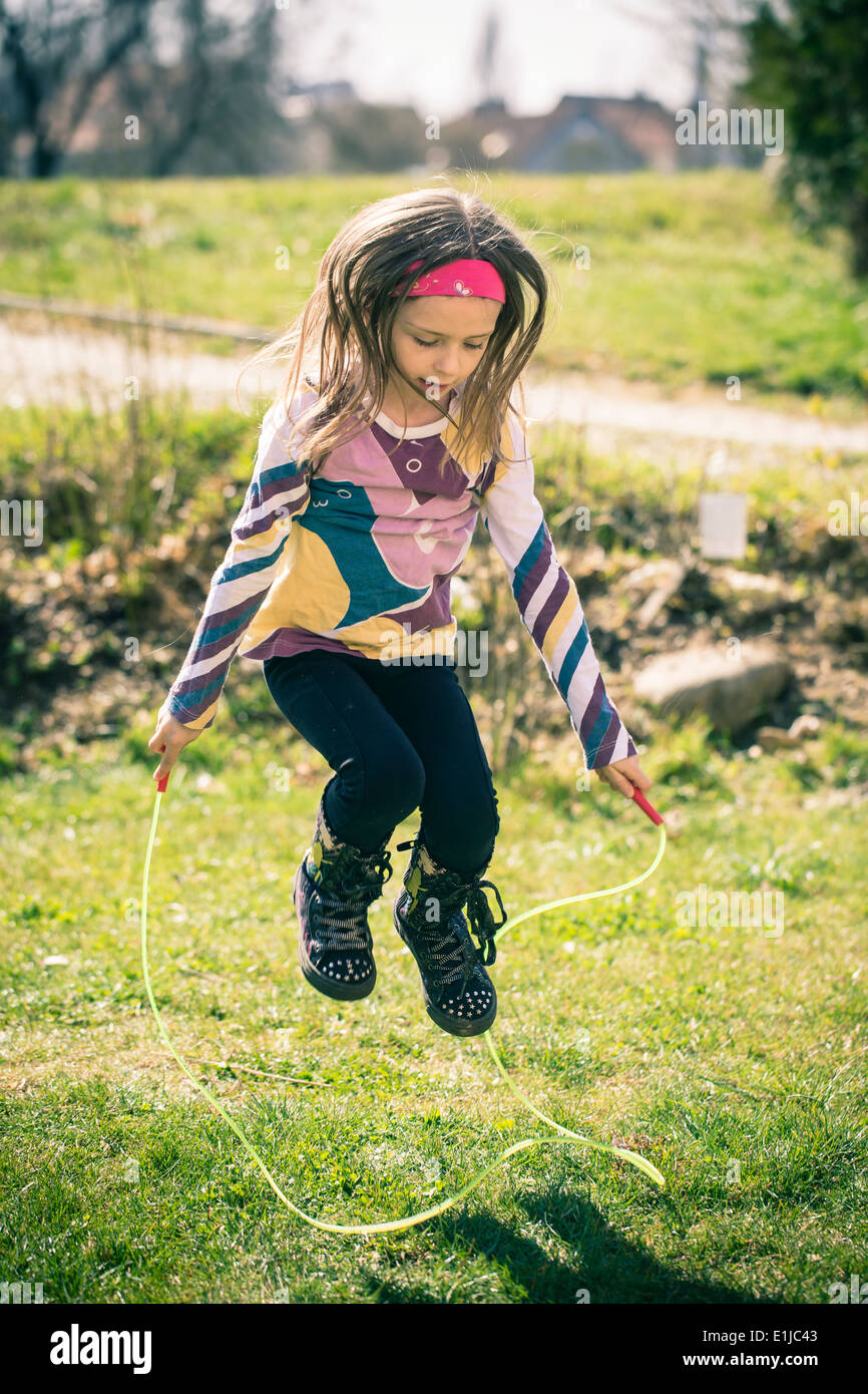 Little girl jumping rope hi-res stock photography and images - Alamy